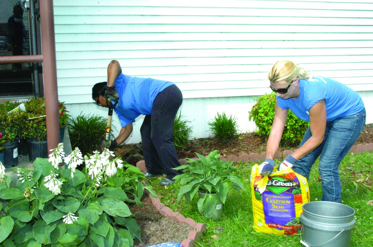 Utility company employees take on installation commmunity service ...