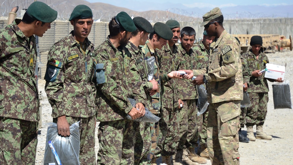 Soldier hands out care packages to Afghan National Army troops ...