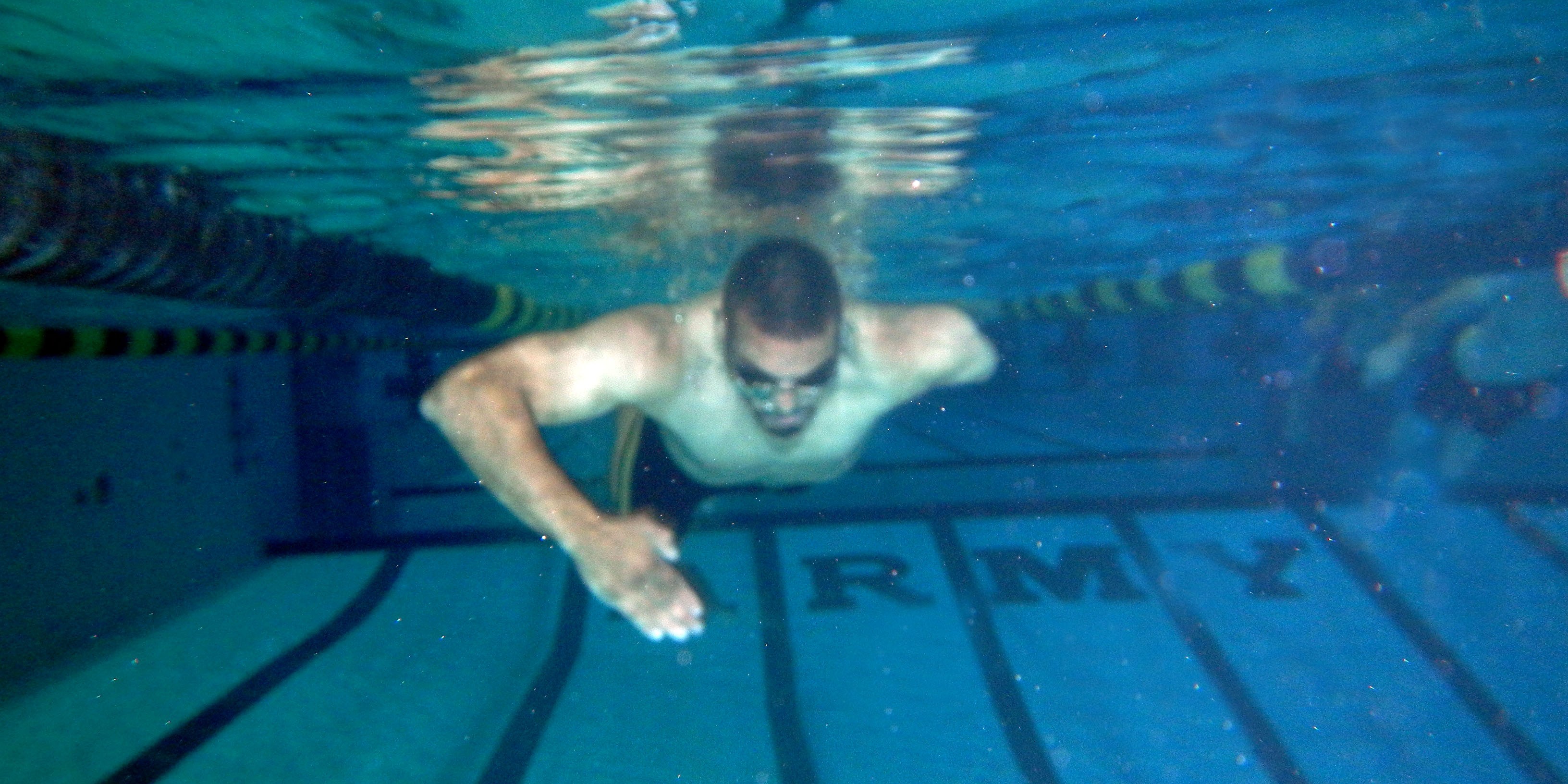 Army veteran Michael Kacer practices the flutter kick exercise during ...
