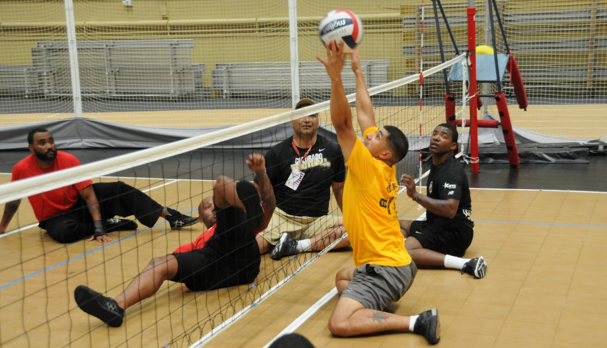 Sgt. Eric Pardo blocks a ball during sitting volleyball practice ...