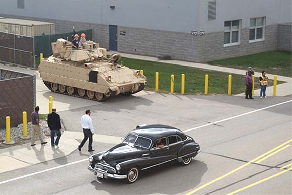 Military, private and commercial vehicles cruise the Detroit Arsenal ...