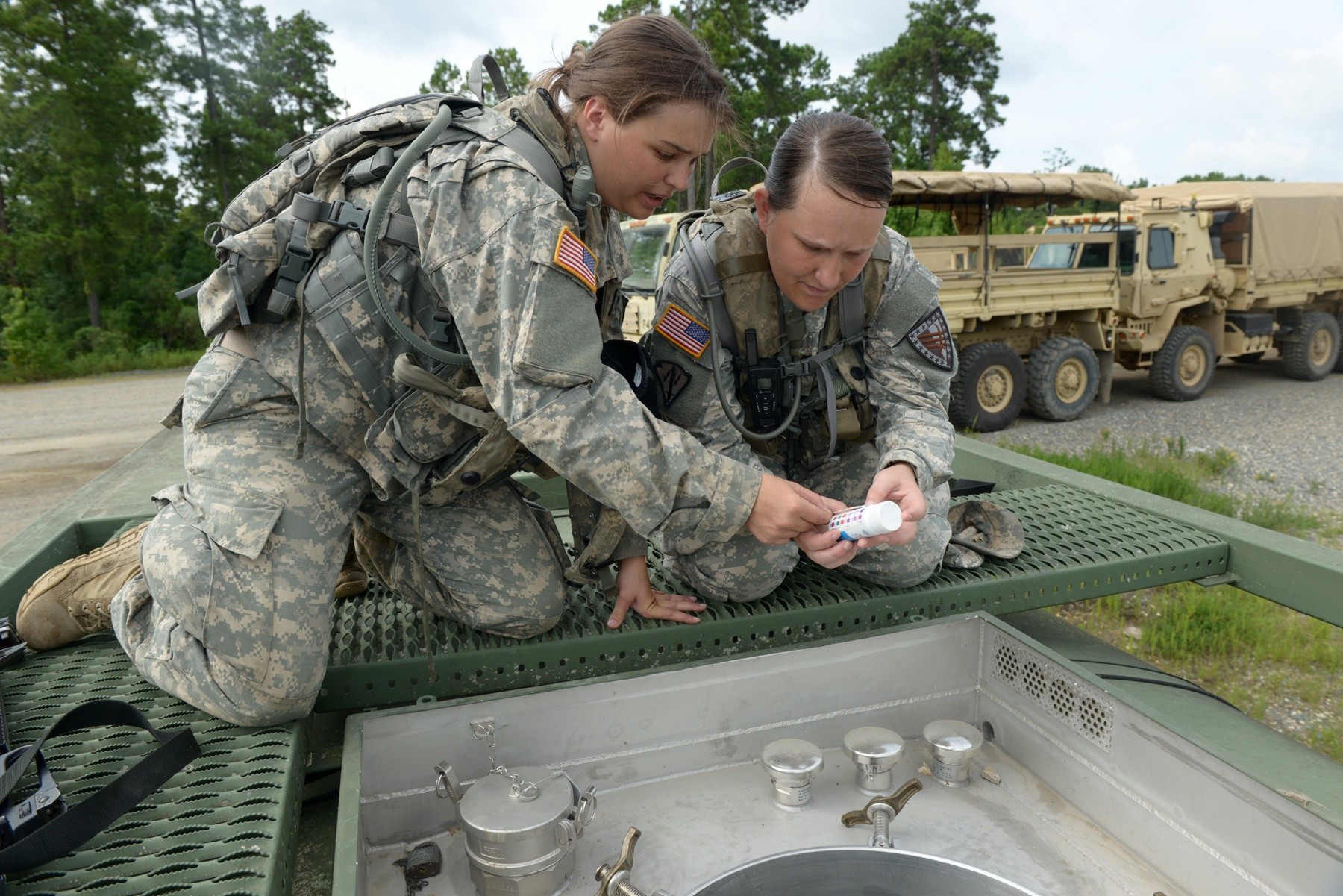 Soldiers with 138th Quartermaster bear water to keep the 76th troops ...