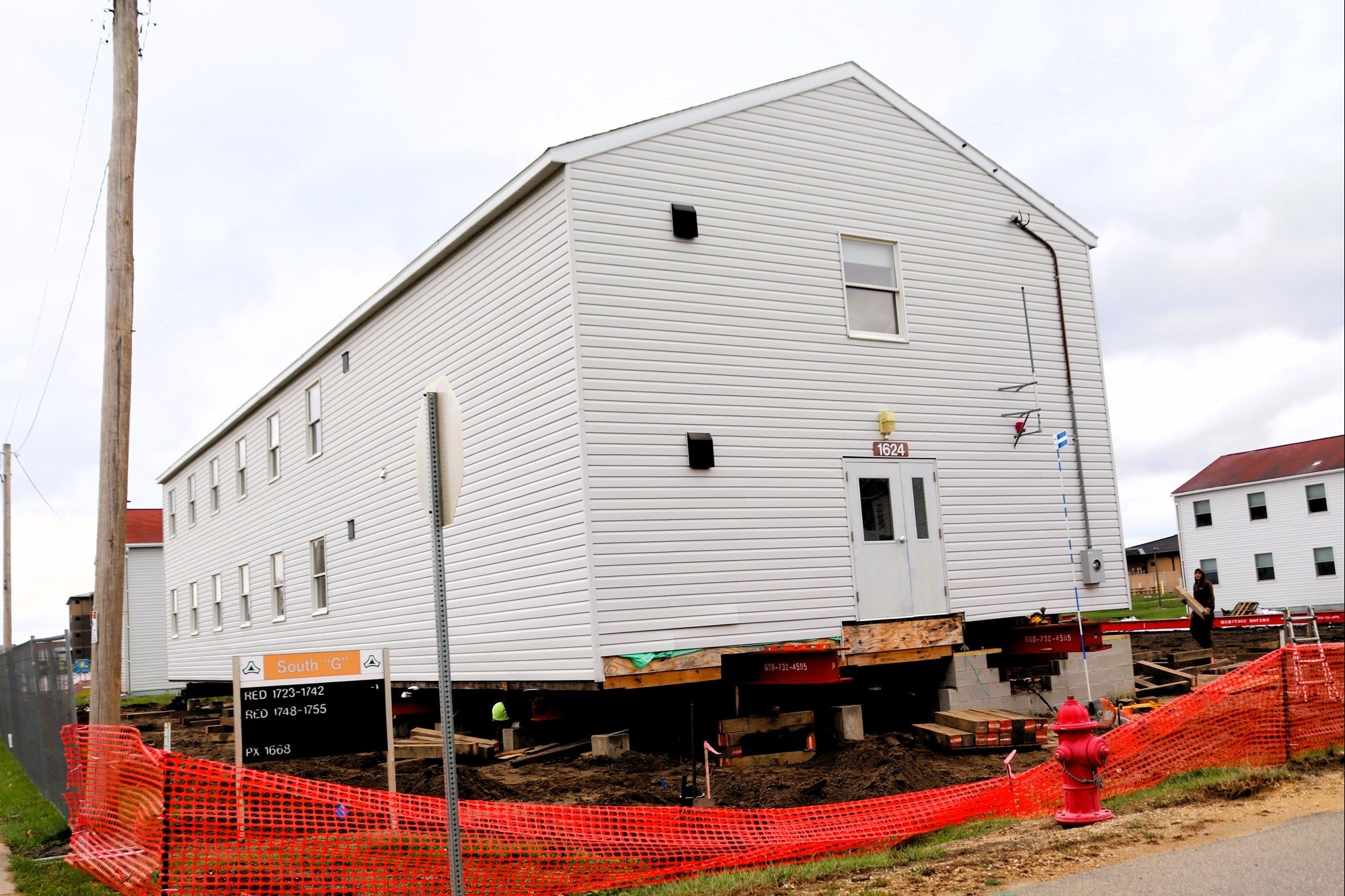 Contractors ‘drive’ World War II-era barracks buildings to new ...