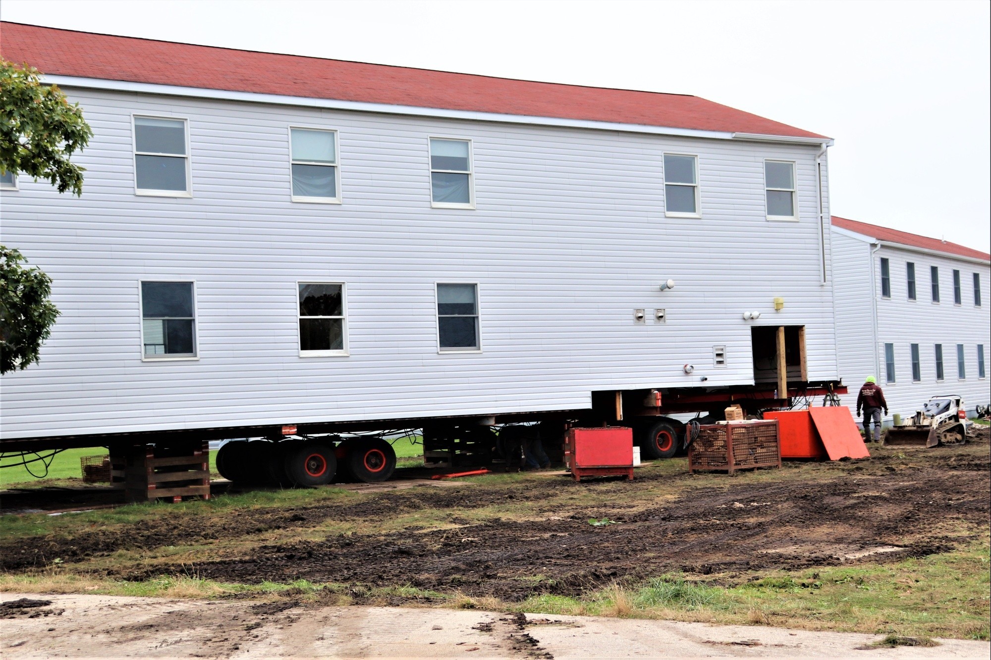 Contractors ‘drive’ World War II-era barracks buildings to new ...